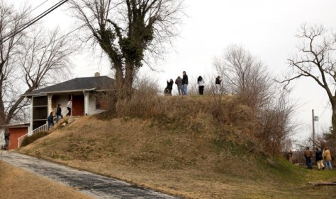 A group of people from the Osage Nation tour a Native American mound in ...